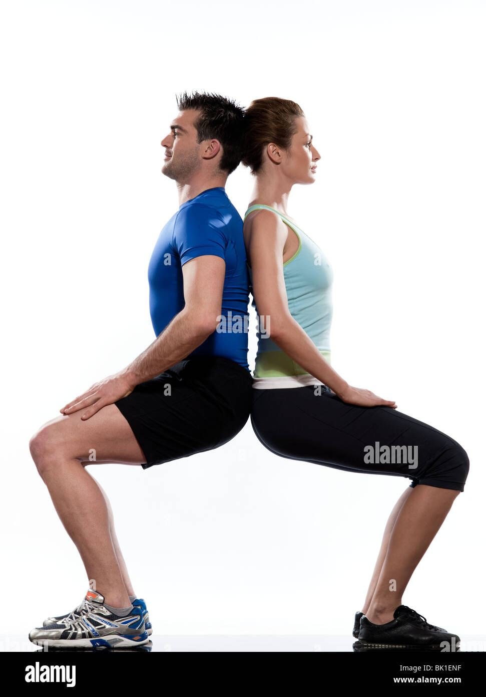 couple doing workout back to back on white isolated background Stock ...