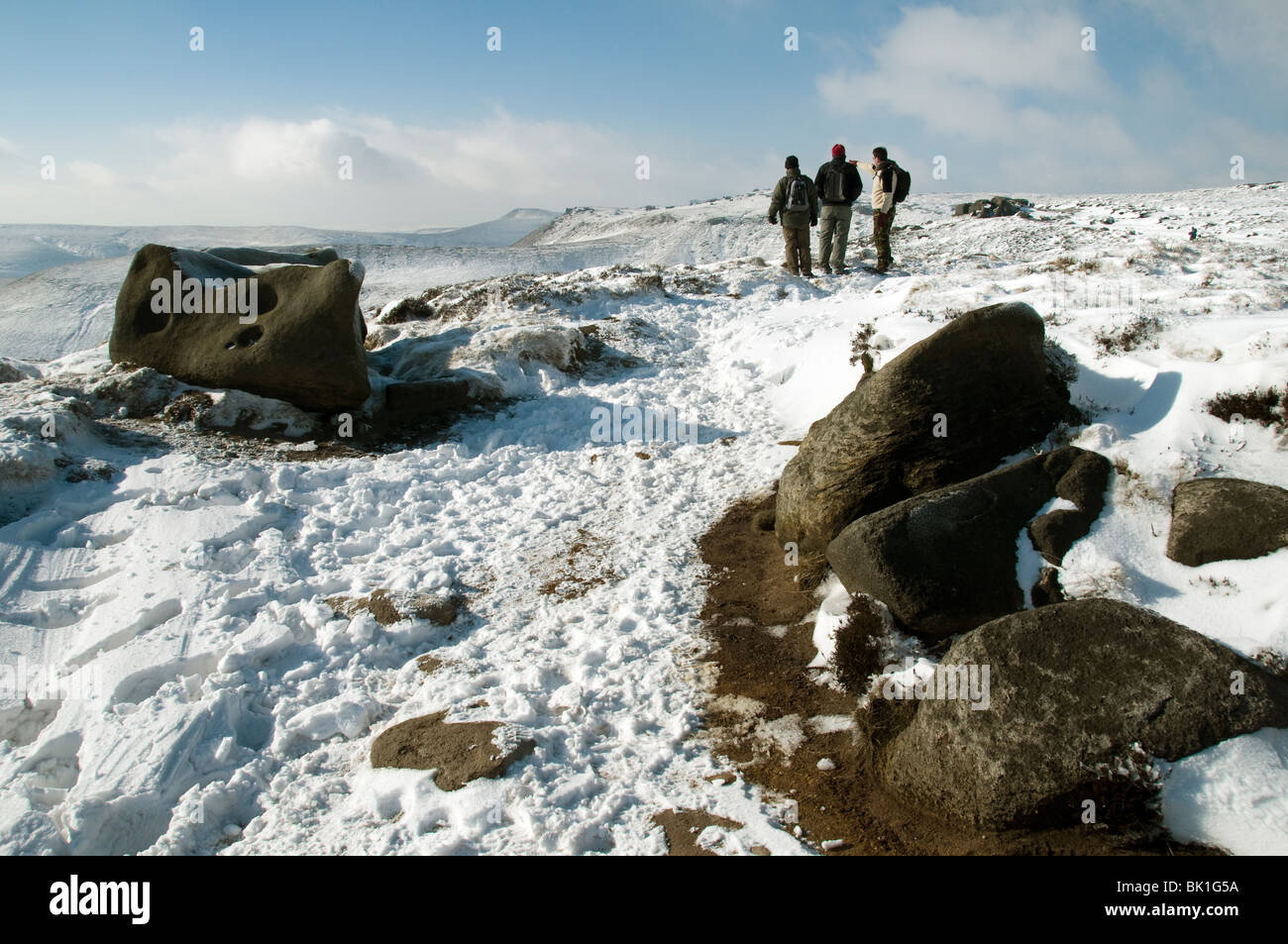 Walkers and wind sculpted Millstone Grit rocks on the Kinder Scout ...