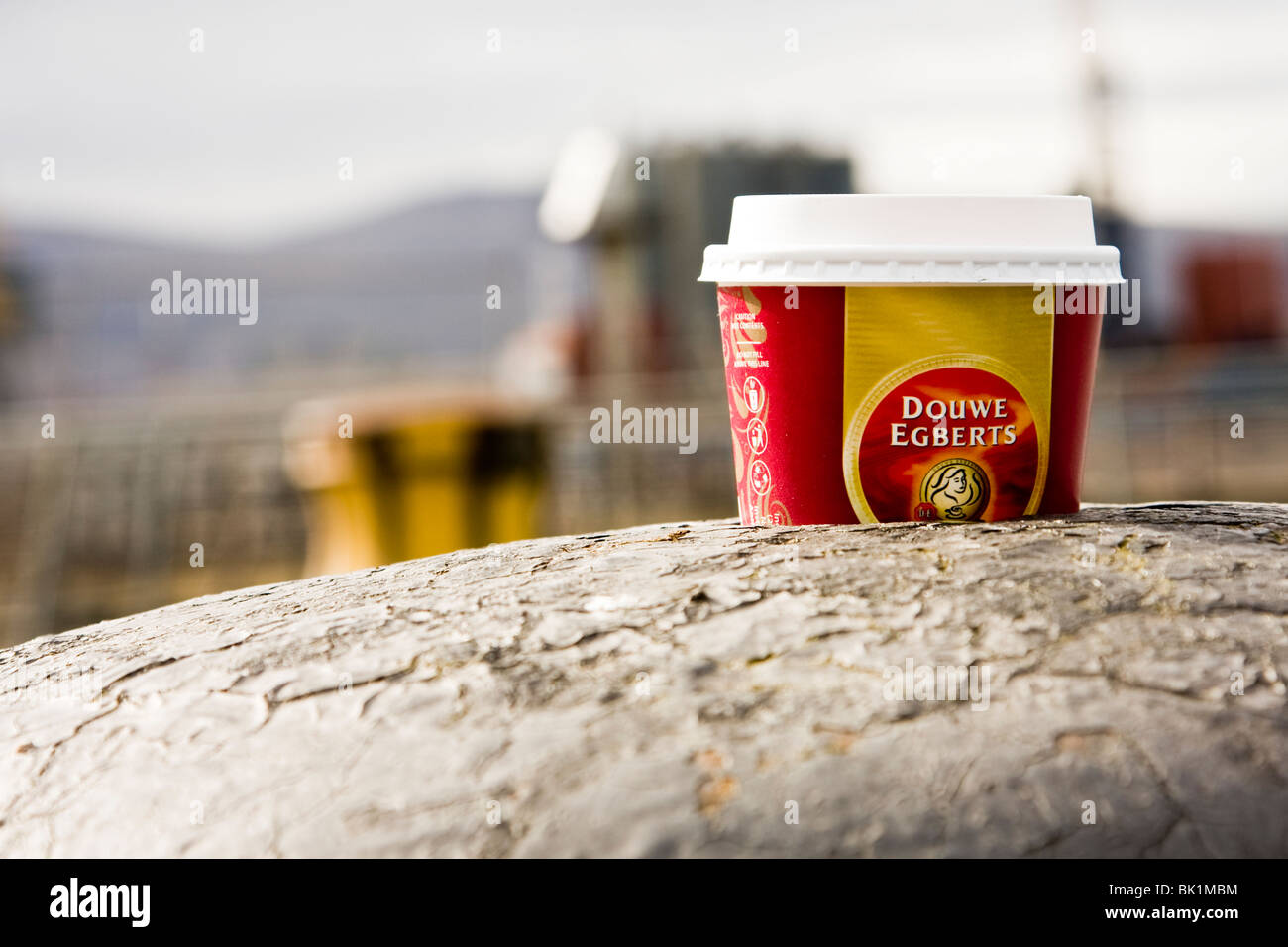 Douwe Egberts coffee cup on bollard with industrial background Stock ...