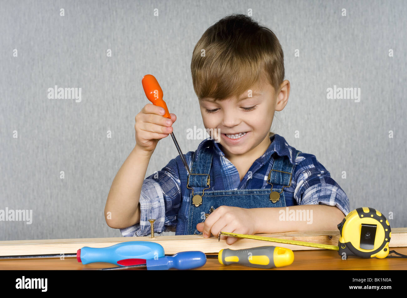 Cute kid as a construction worker, playing with tools Stock Photo - Alamy