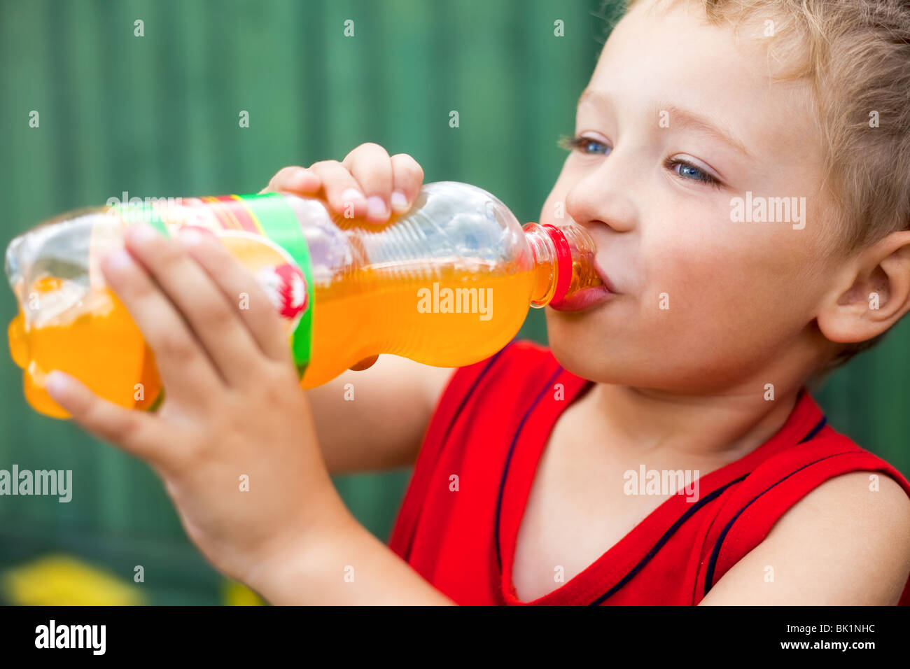 Little boy drinking unhealthy bottled soda Stock Photo - Alamy