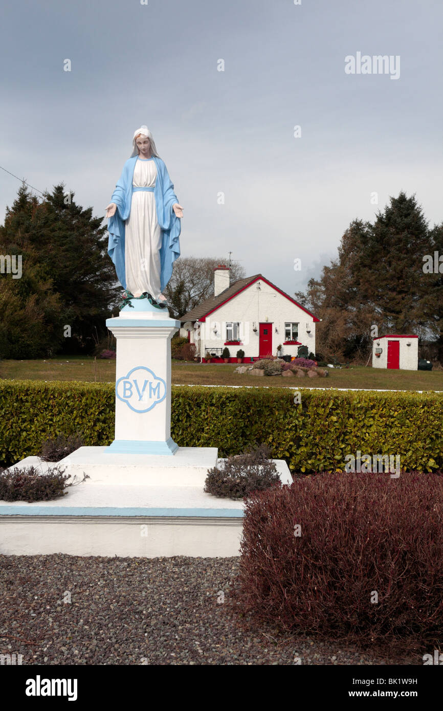Statue of the Virgin Mary in front of a cottage on the Dingle Peninsula ...