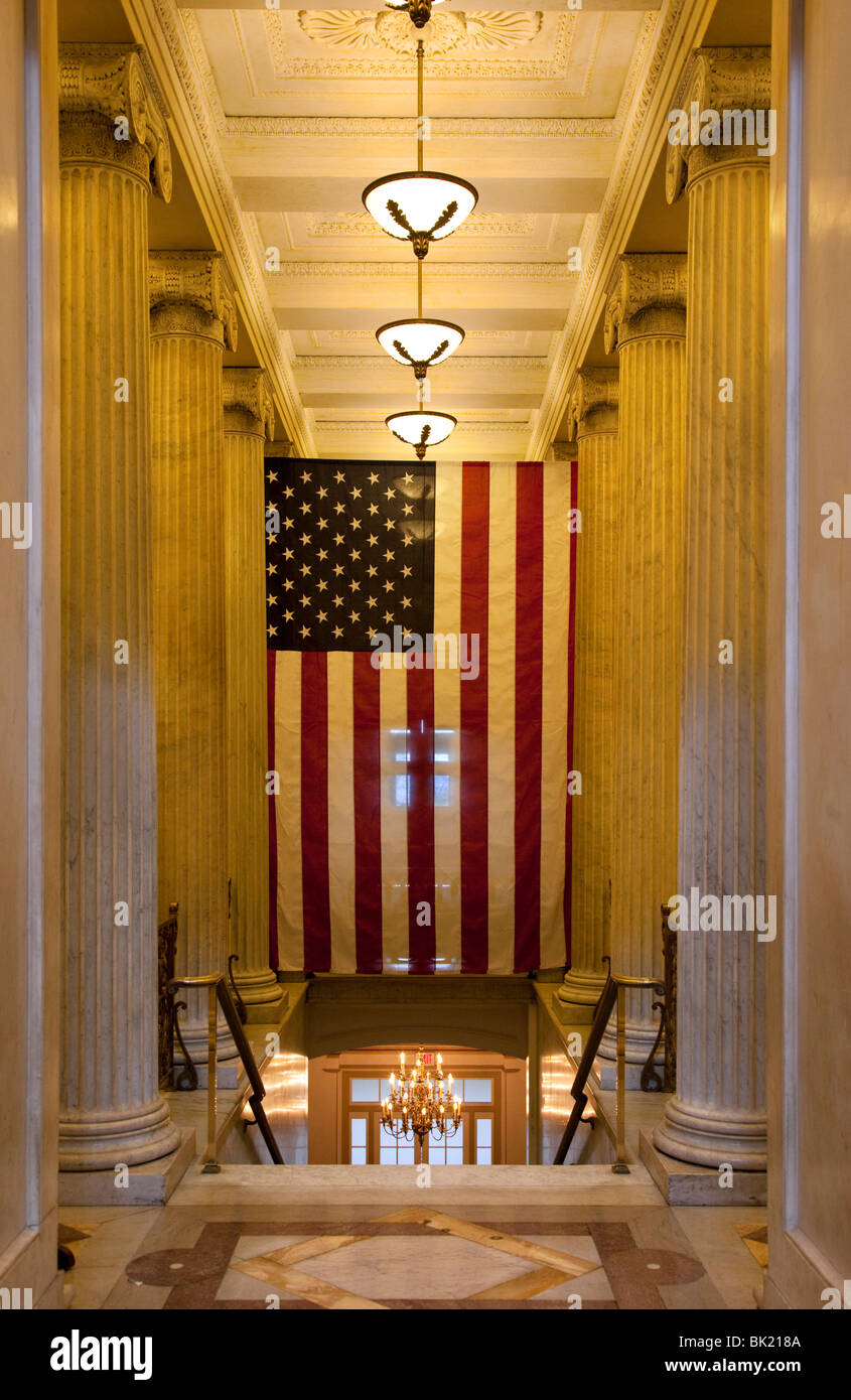 American flag hangs over a staircase in the US Capitol Building in ...
