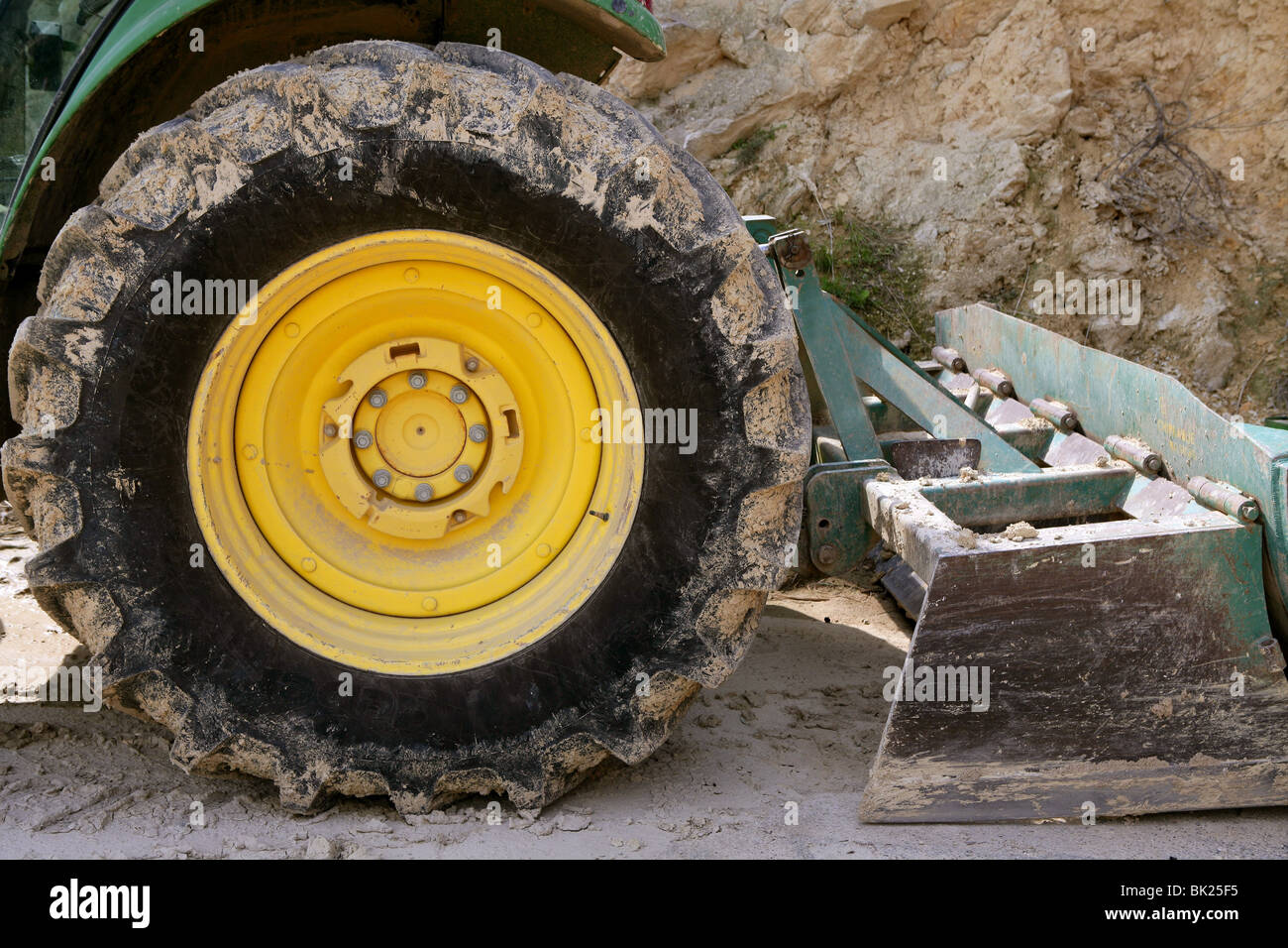 Backhoe bulldozer working hard with stones Stock Photo - Alamy
