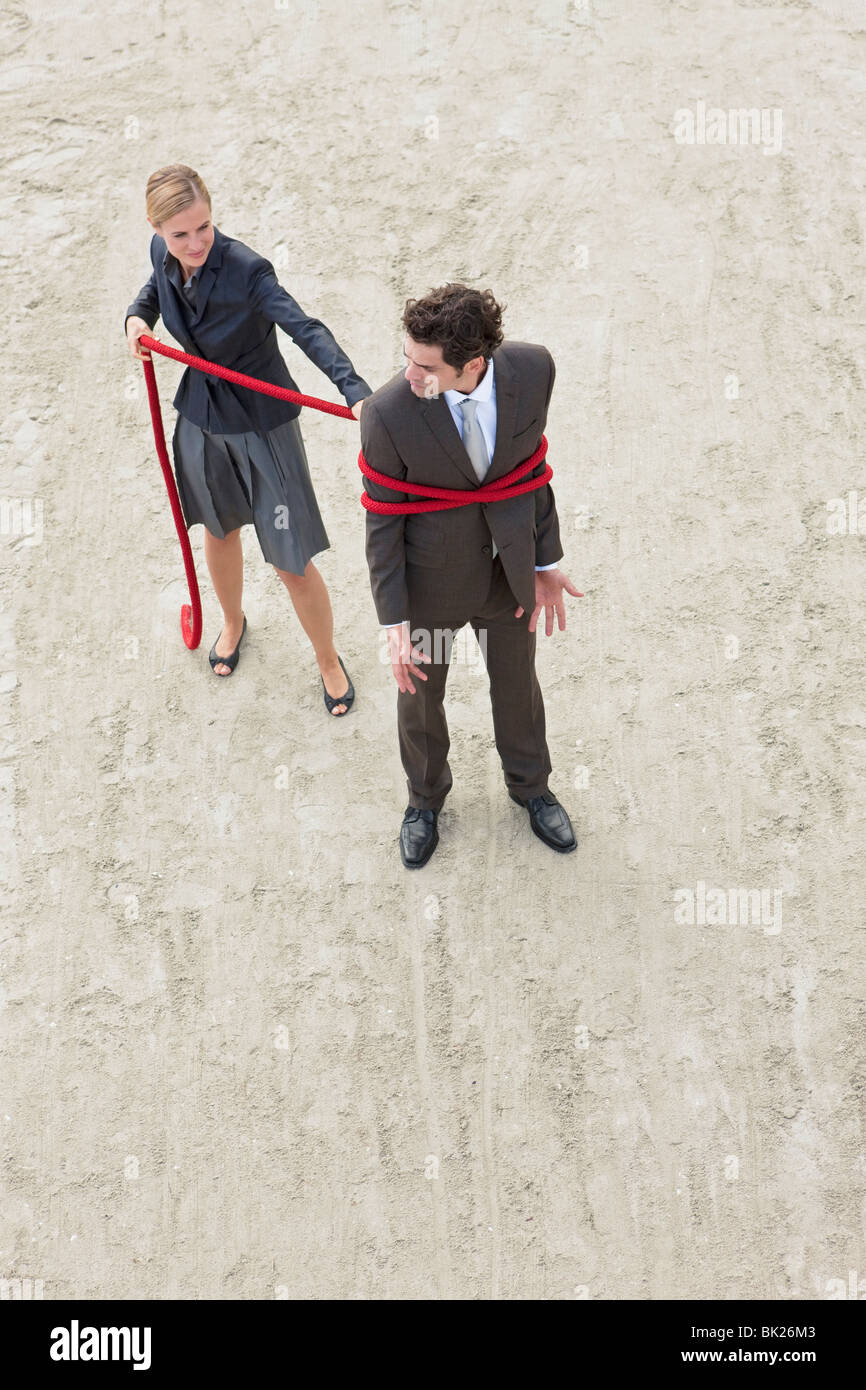 Woman businessman tied up rope hi-res stock photography and images - Alamy