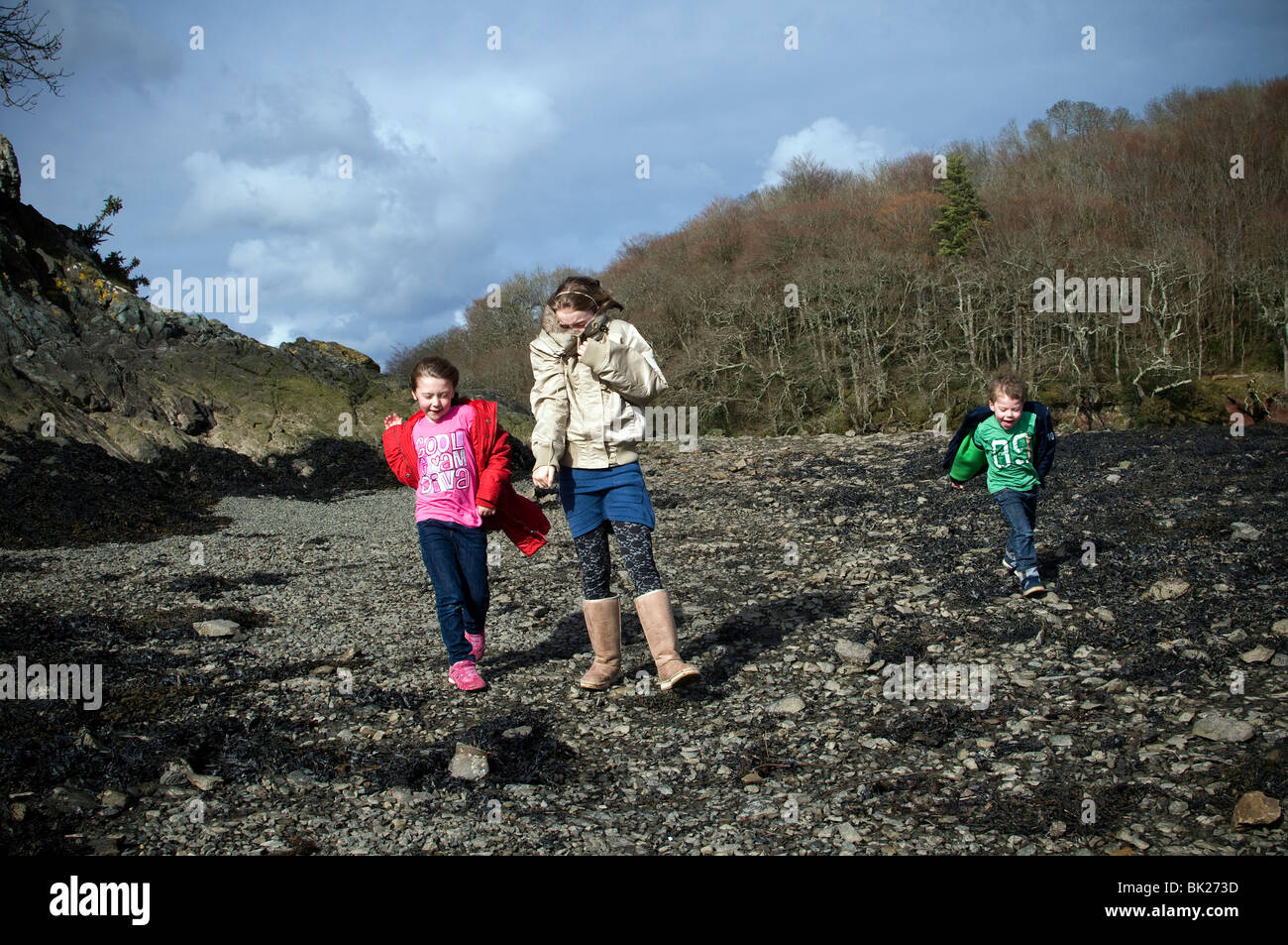 Children exploring on windy Devon shoreline near Stoke Gabriel Stock ...