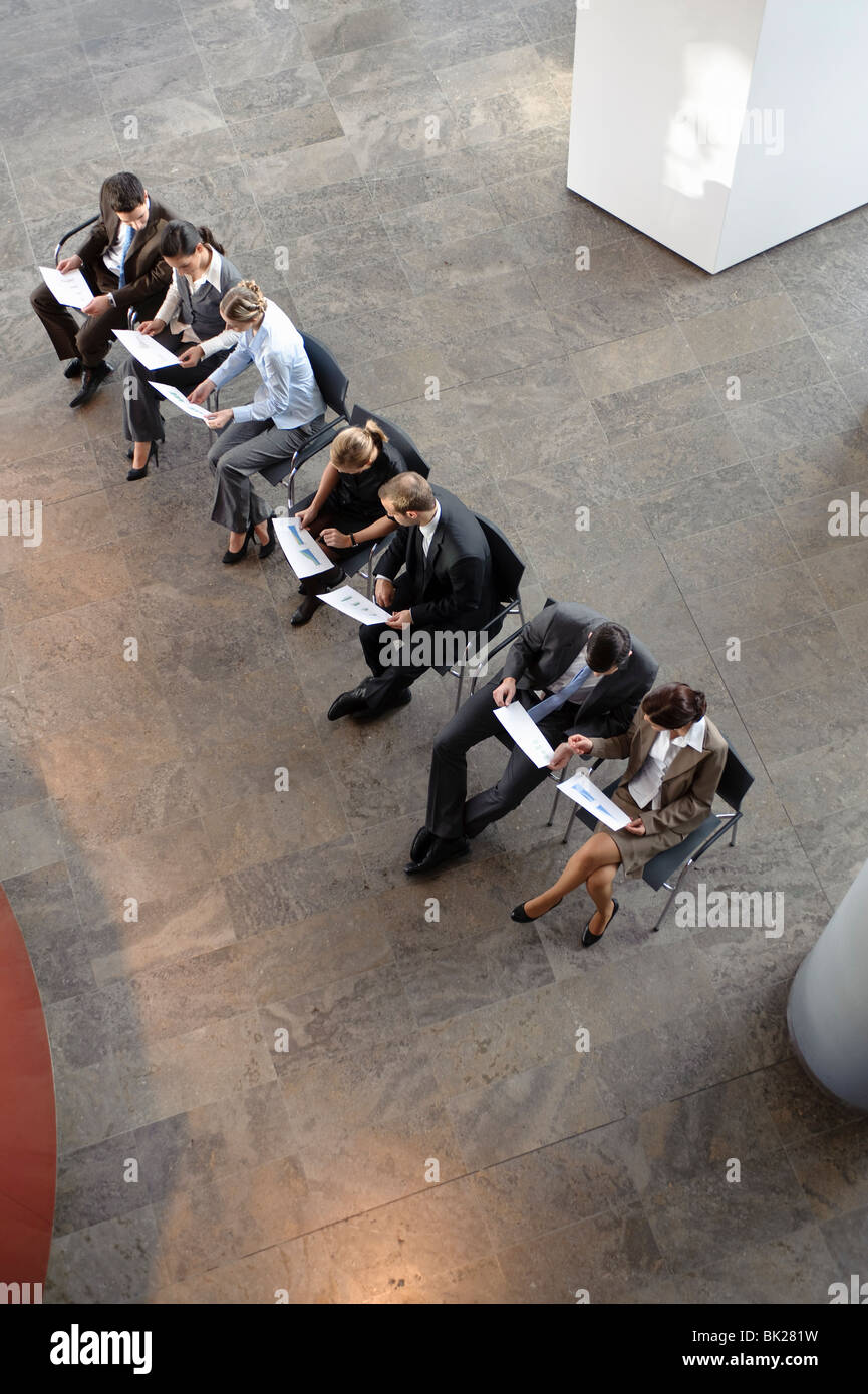 People sitting working with papers Stock Photo - Alamy