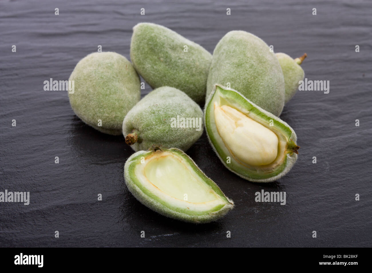 Green Almonds also known as Bitter Almonds against dark slate ...