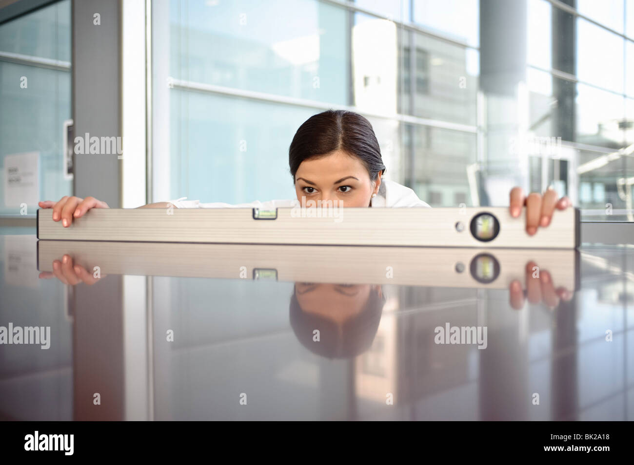 Business woman using spirit level Stock Photo - Alamy