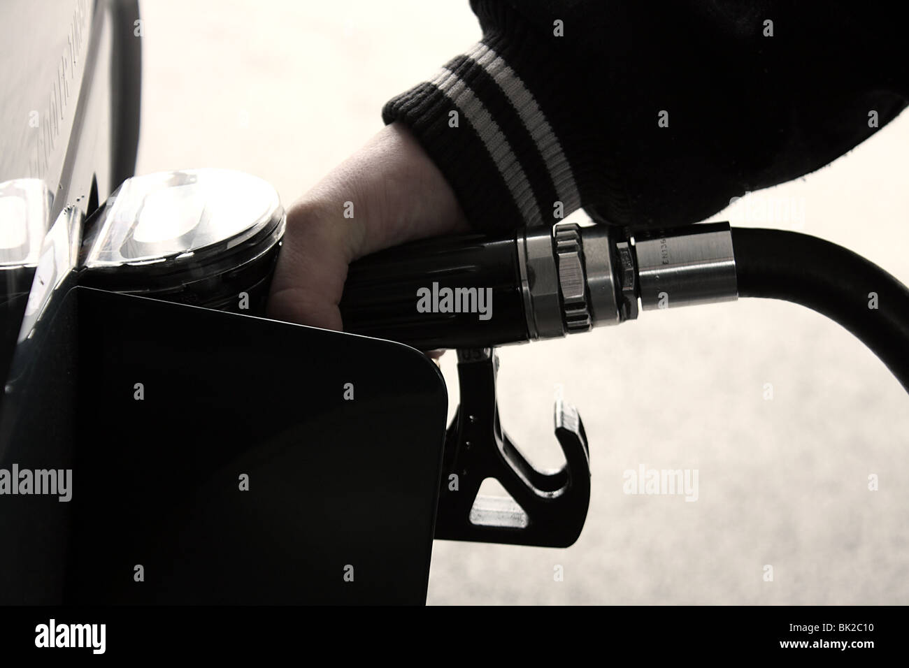 Using a petrol pump to fill the car with petrol Stock Photo - Alamy