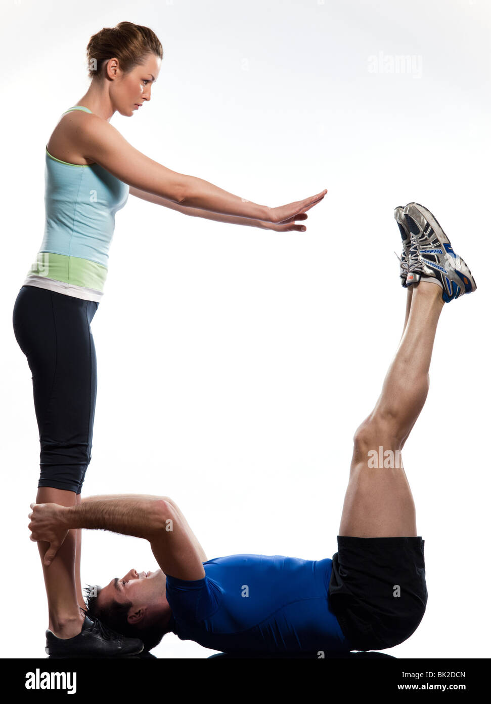 couple,man and woman doing abdominals workout push ups posture on ...