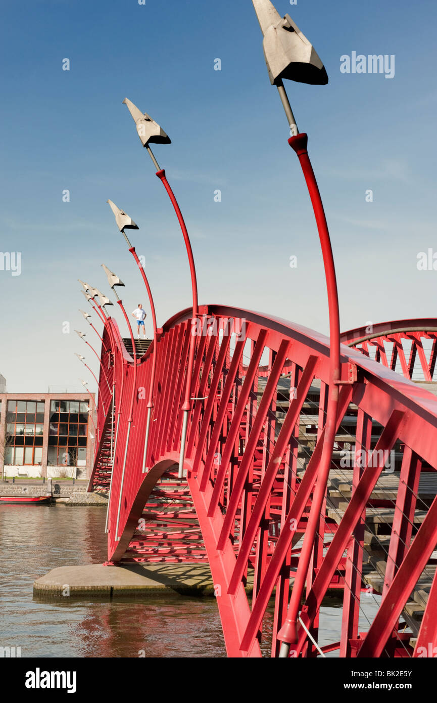 Modern red steel footbridge called Pythonbrug connecting new Borneo and ...