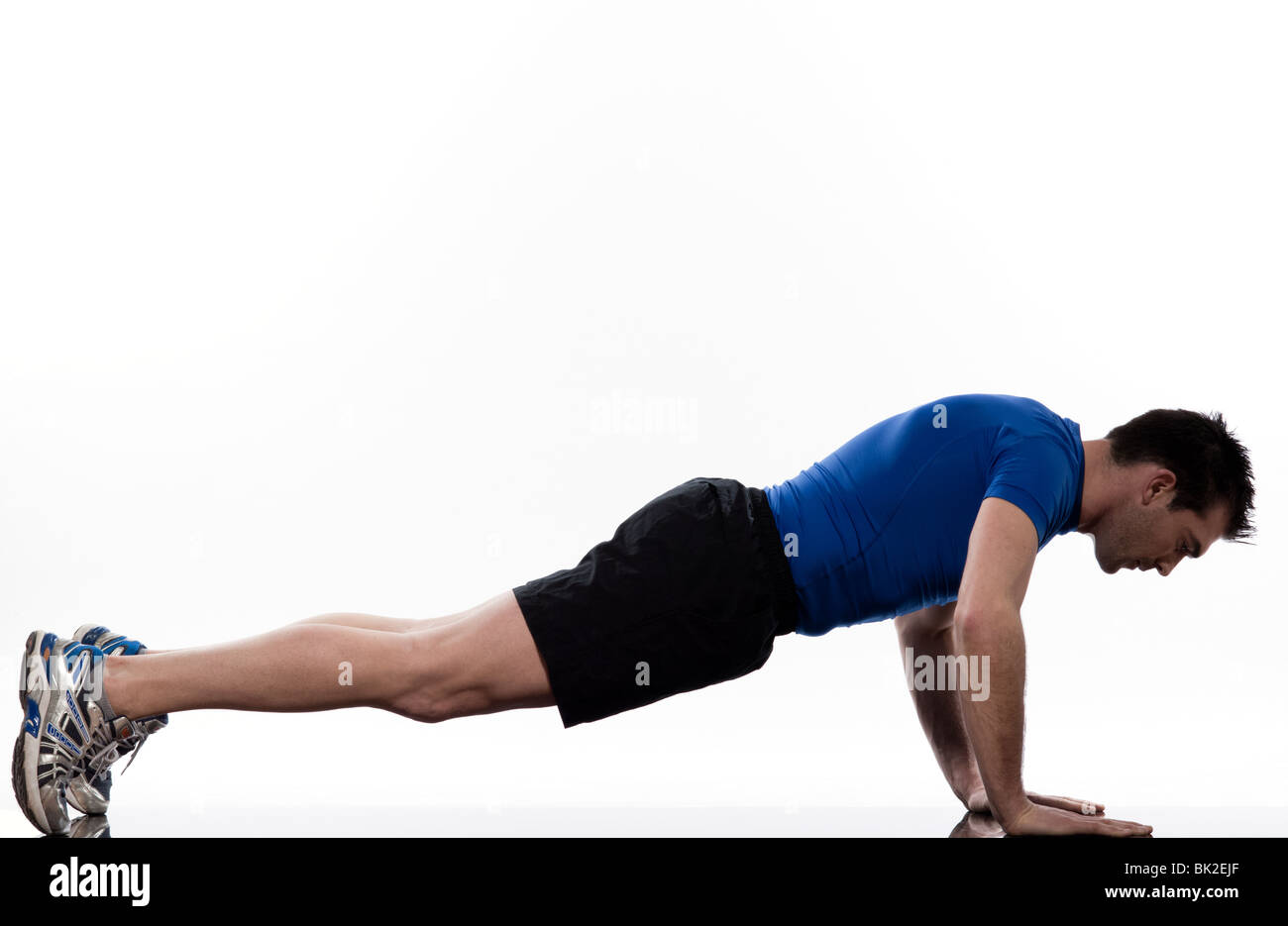 man doing push up abdominals workout posture on isolated white ...