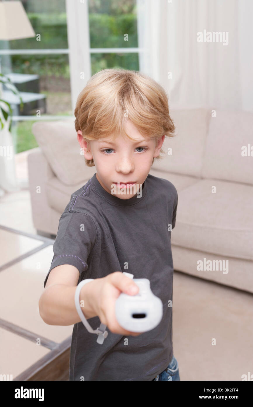 A boy pointing a games console to camera Stock Photo - Alamy