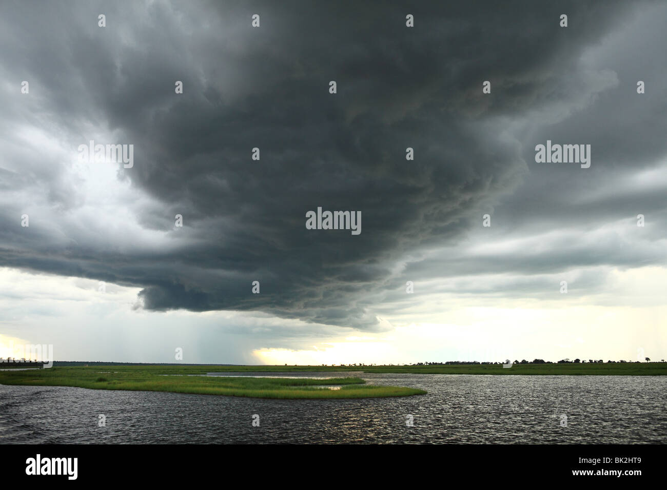 A thunder storm moves across the horizon with dark clouds over the ...