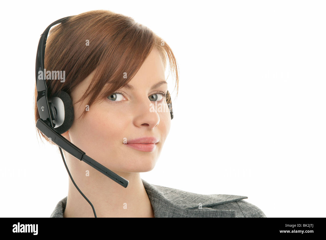 Portrait of friendly secretary/telephone operator wearing headset ...