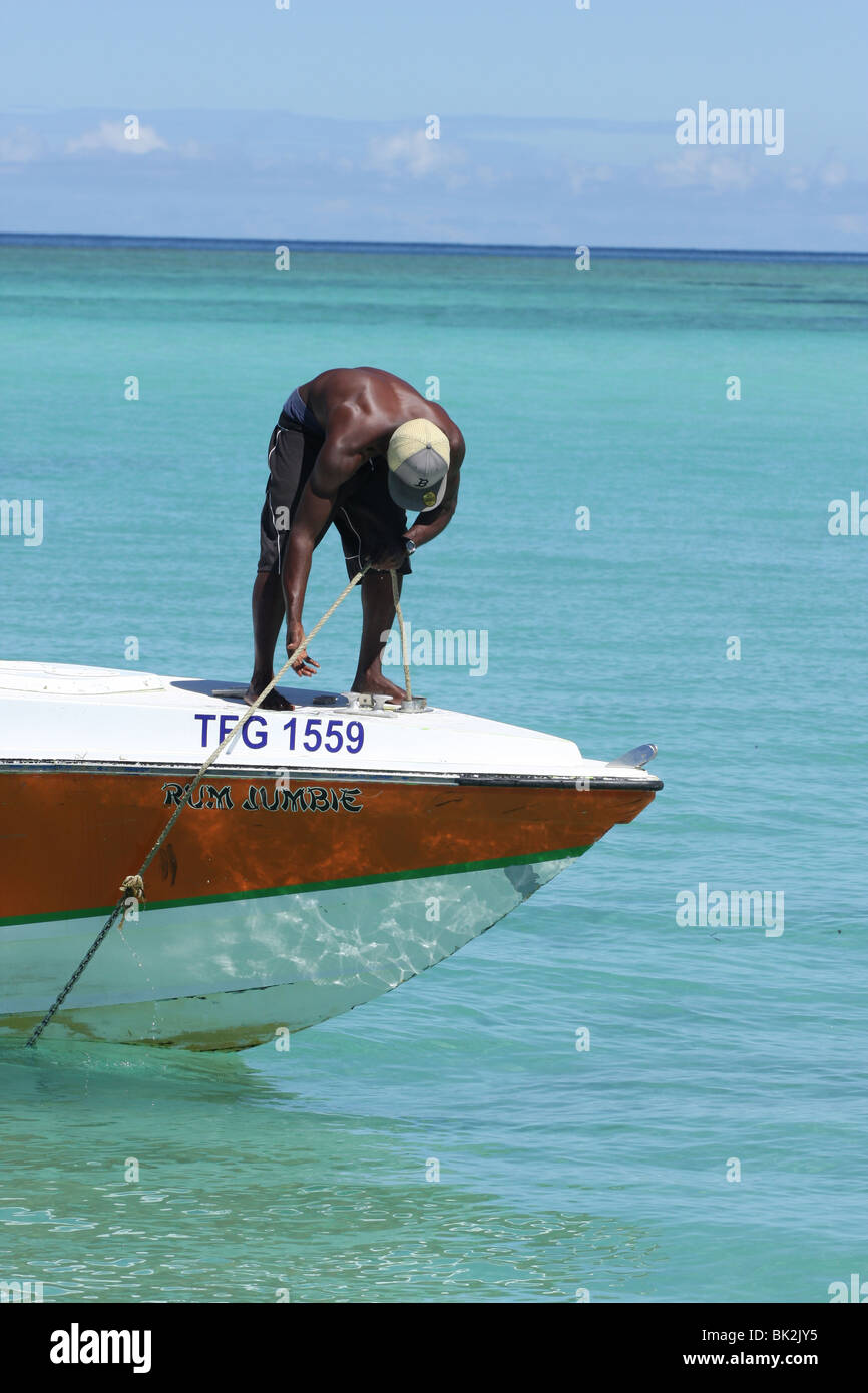 Man on motor boat tobago Stock Photo - Alamy