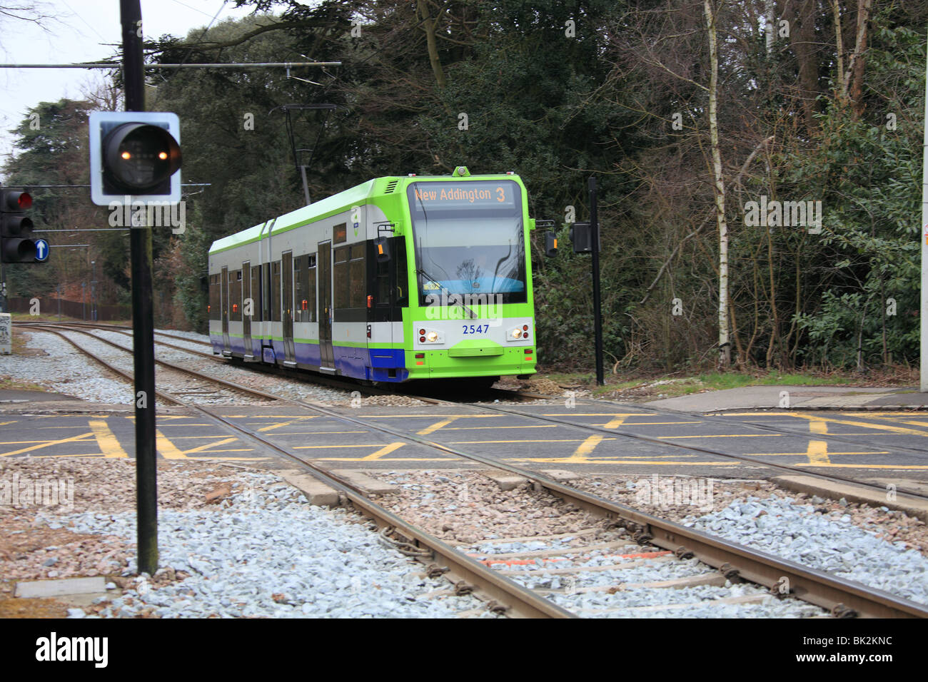 Passenger carrying trams of the Croydon Tramlink at a level crossing in ...