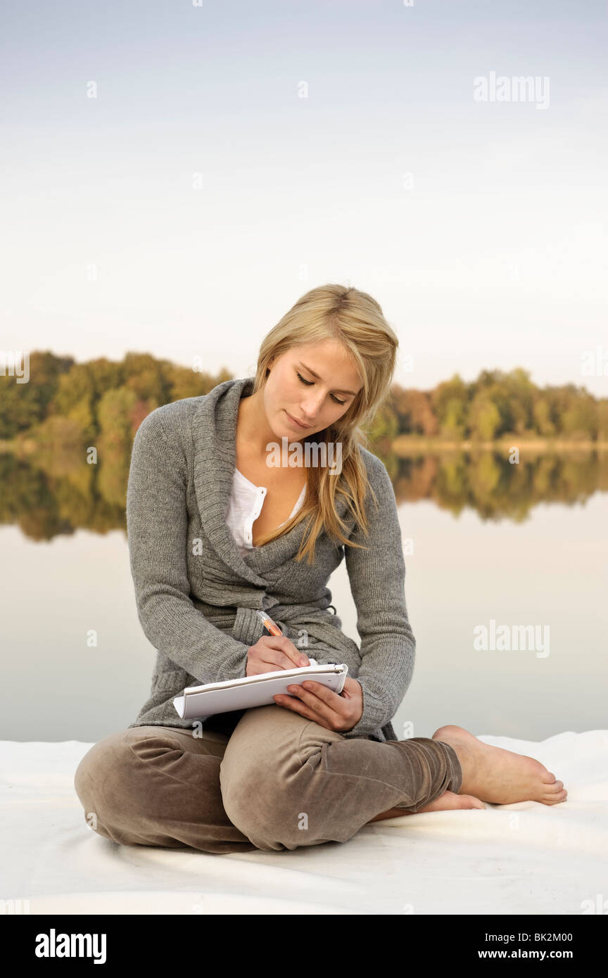 Woman siting writing hi-res stock photography and images - Alamy