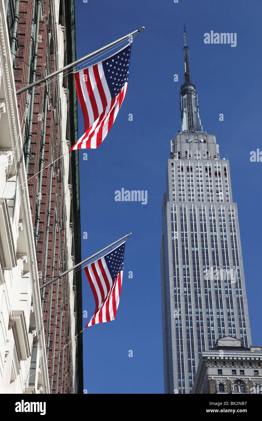 Empire State Building with United States flags Stock Photo - Alamy