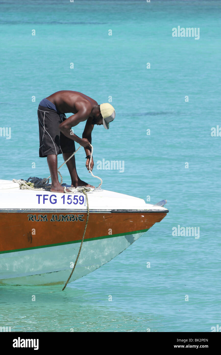 Man on motor boat tobago Stock Photo - Alamy