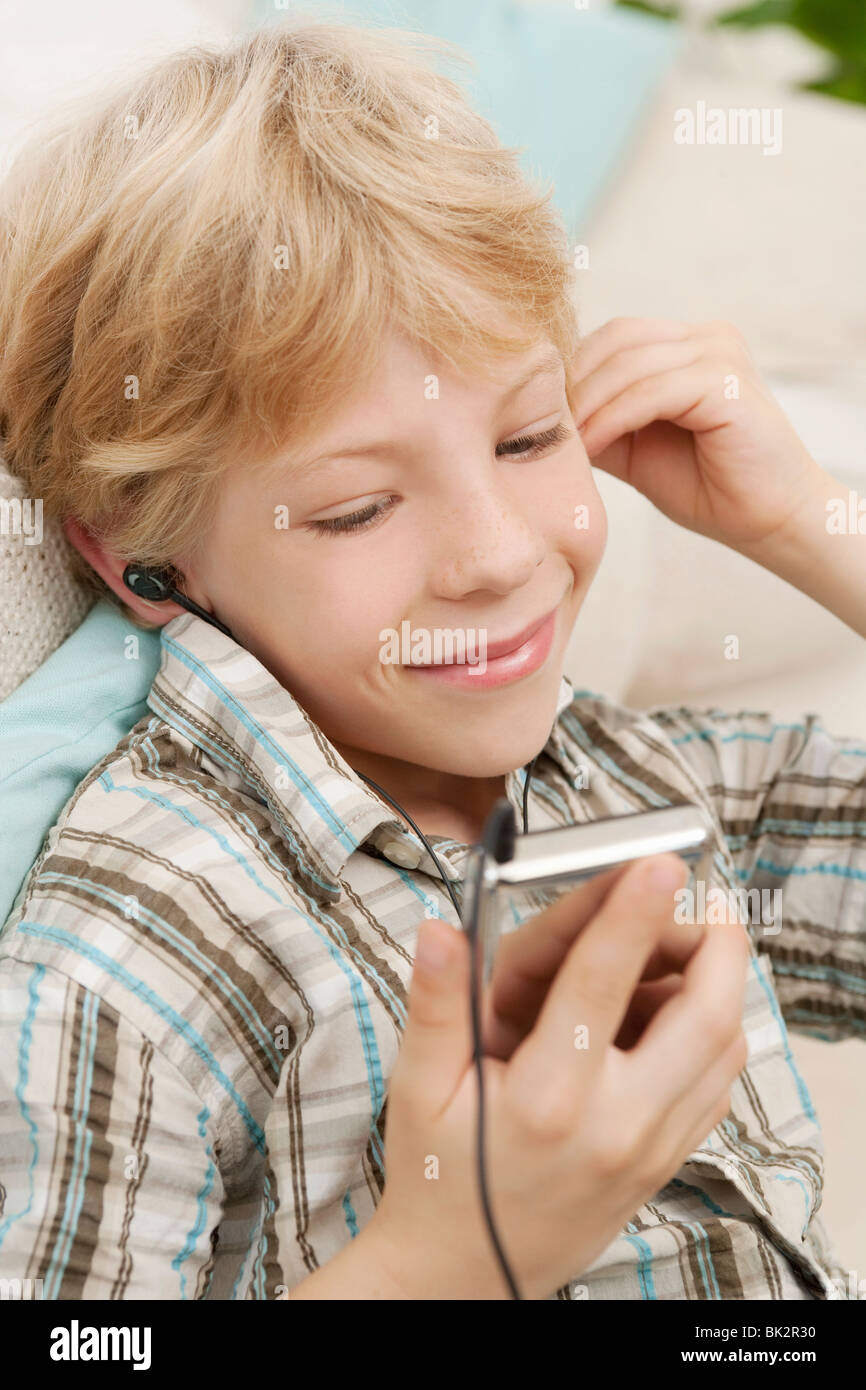 A boy listening to an MP3 player Stock Photo - Alamy