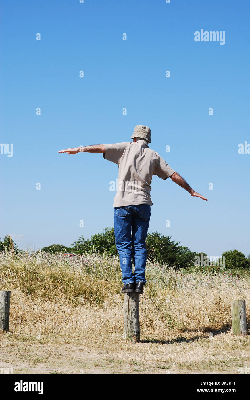 Mature man balancing Stock Photo - Alamy
