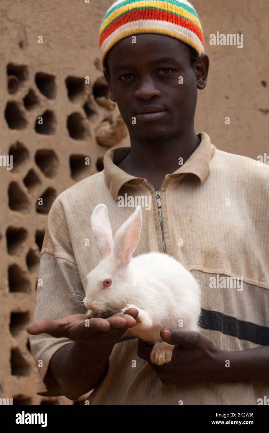 Young man with rabbit, which are bred for meat. Rwanda Stock Photo - Alamy