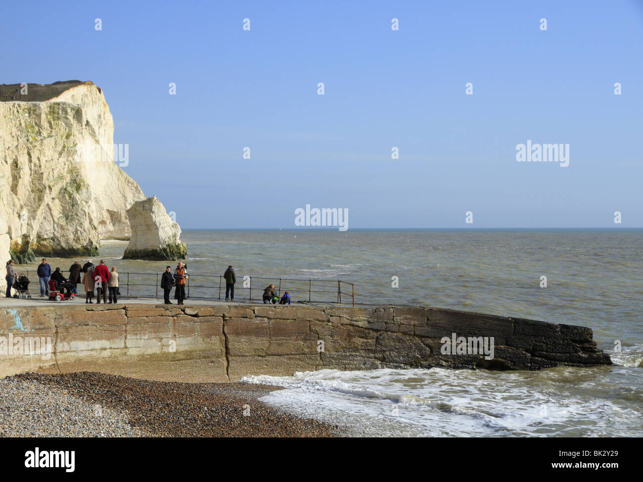 Visitors to Seaford Beach admire the view towards the Sea Stack beneath ...