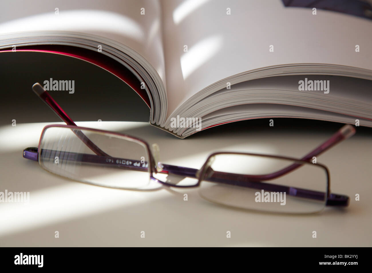 Open book with glasses Stock Photo - Alamy