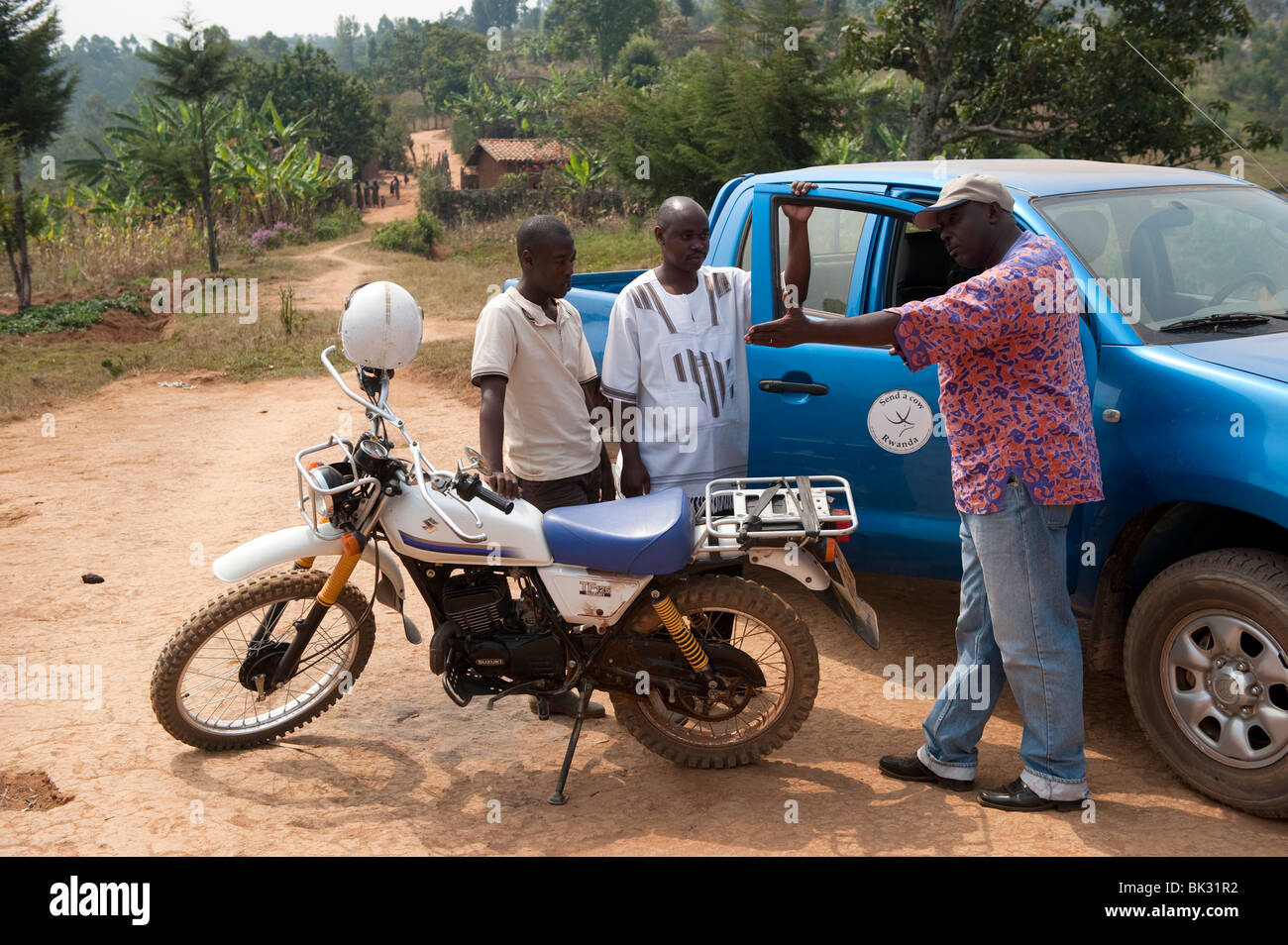 Aid workers talking to local community members, Rwanda Stock Photo - Alamy
