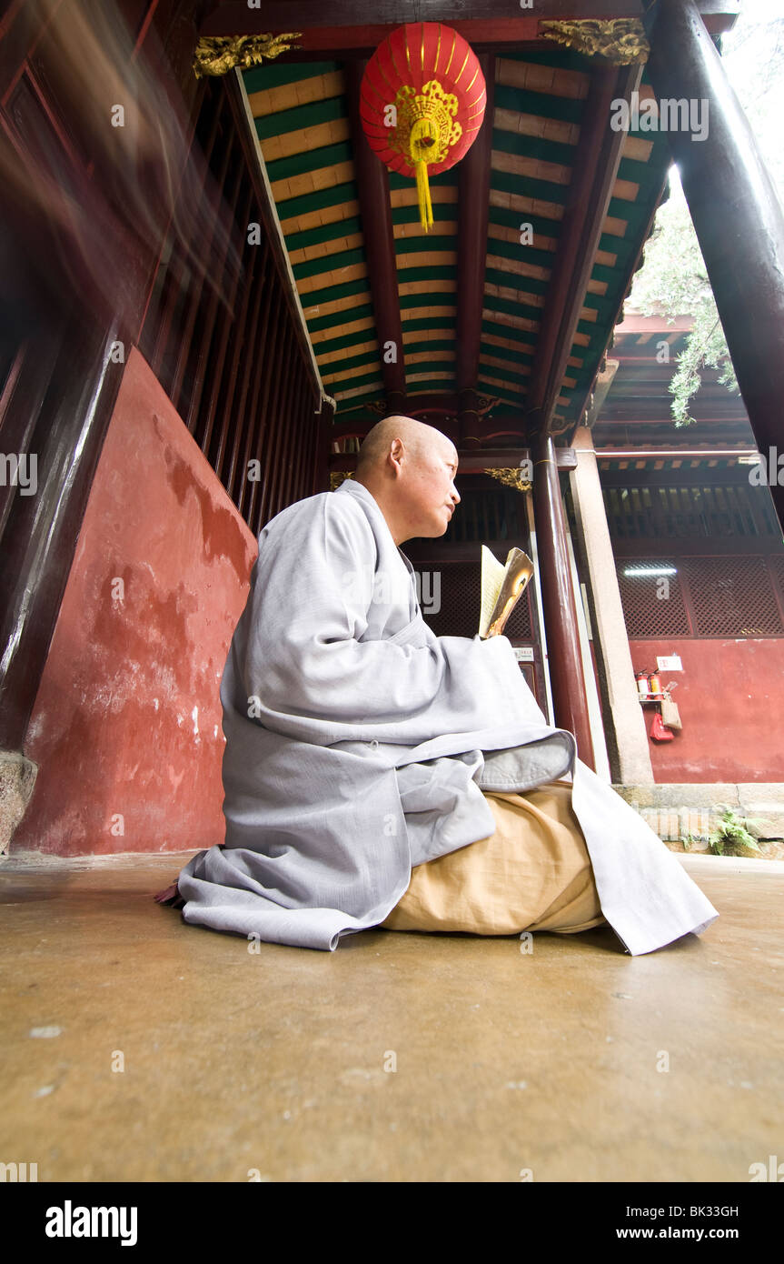 A Buddhist monk praying inside Kaiyuan temple Stock Photo - Alamy