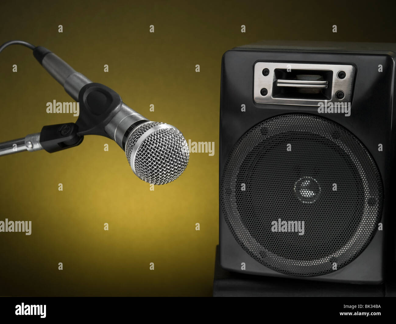 Microphone and speaker over a yellow background Stock Photo - Alamy