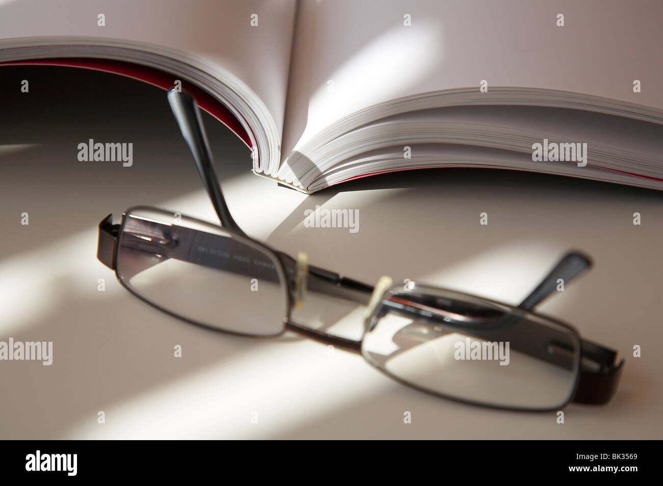 Open book with glasses Stock Photo - Alamy