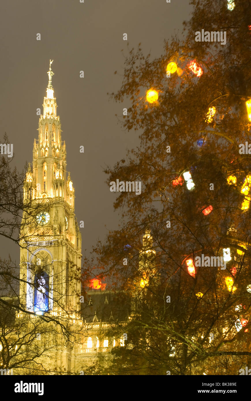 Tree decorated with lit Christmas presents and Rathaus tower at ...
