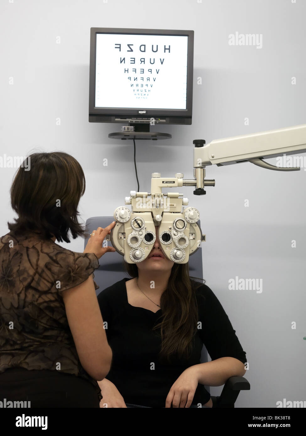 Teenager Having An Eye Test Using Phoropter At Opticians Stock Photo ...