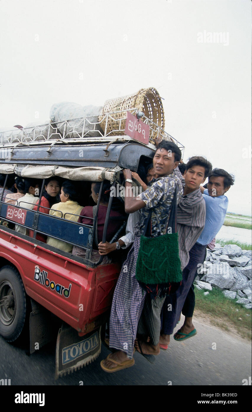 Men hanging on to the back of a small bus, Myanmar Stock Photo - Alamy