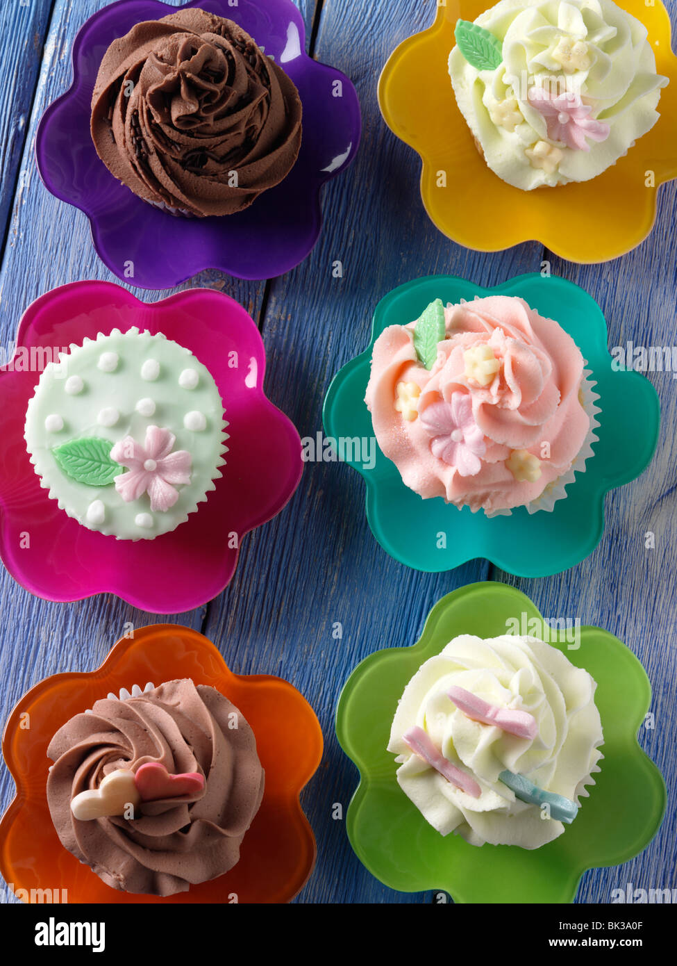 Iced cupcakes on a blue background Stock Photo - Alamy