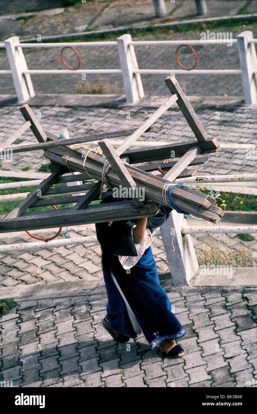 A person carrying a table and lumber on top of their head, Ecuador ...