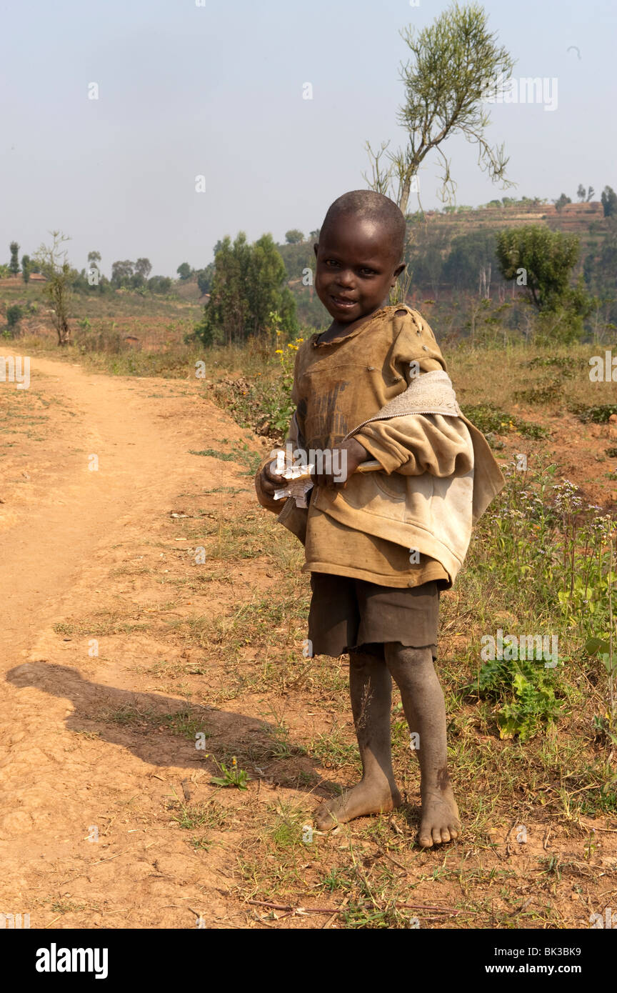 Poor child on roadside in tattered clothing. Rwanda Stock Photo - Alamy