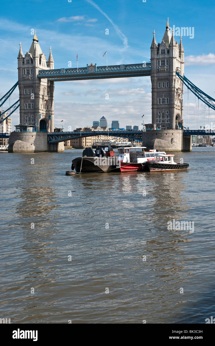 View of the London Tower bridge with anchored boats on the river Thames ...