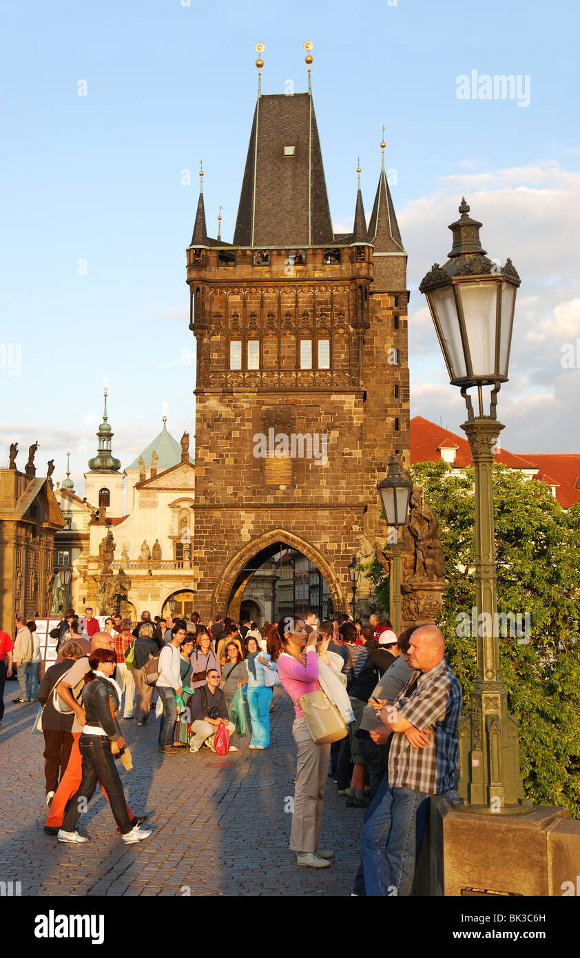 Tourists on Charles bridge in Prague. View to the Old town bridge tower ...