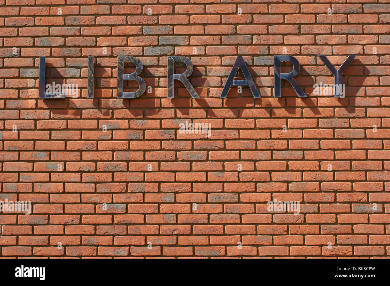 Library sign on a brick wall Stock Photo - Alamy