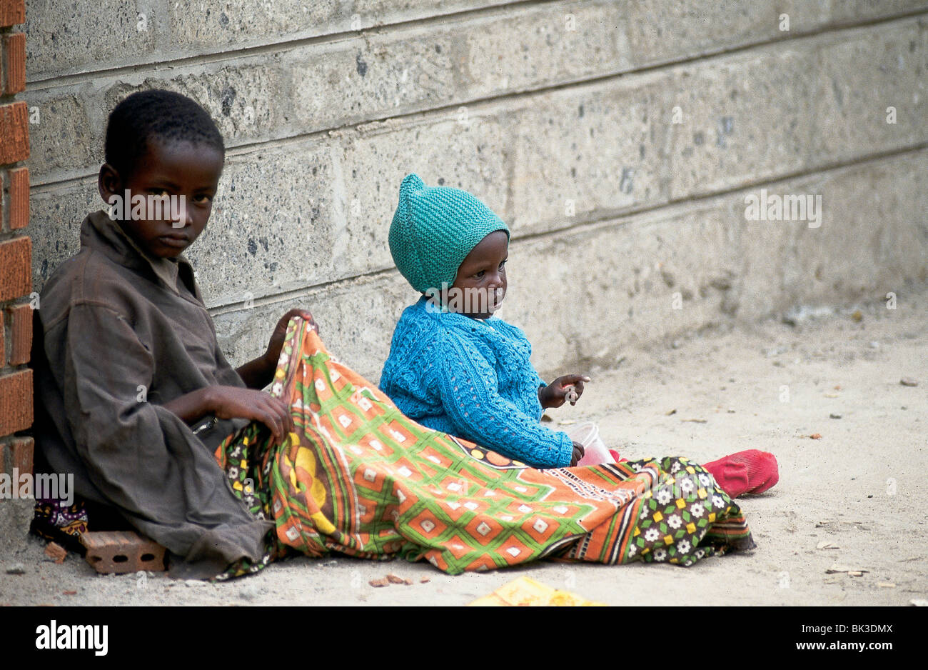 Two Kenyan children sitting on the streets of Nairobi, Kenya Stock ...