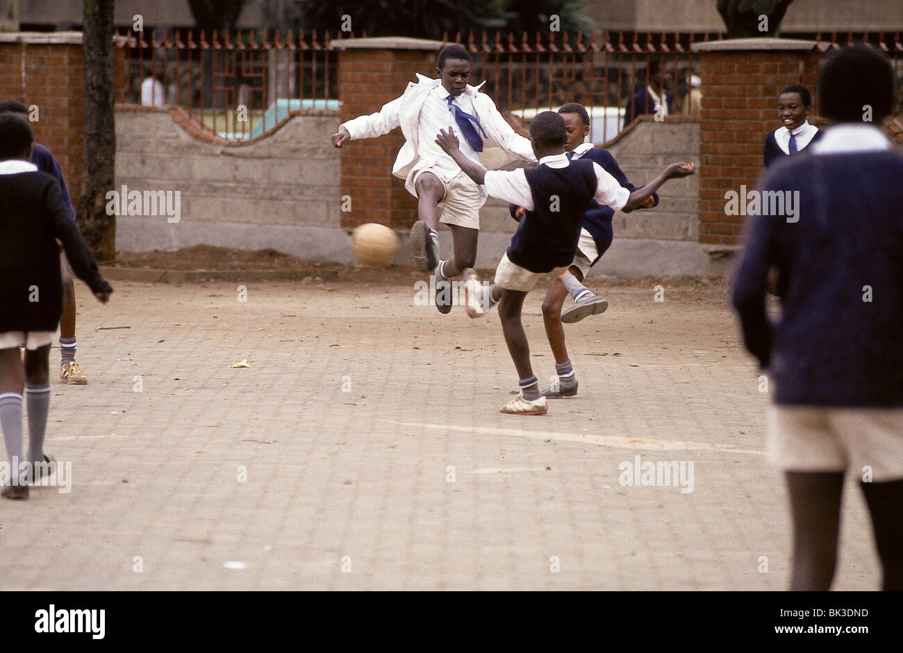 Kenyan school children in uniforms playing soccer, Nairobi Stock Photo ...