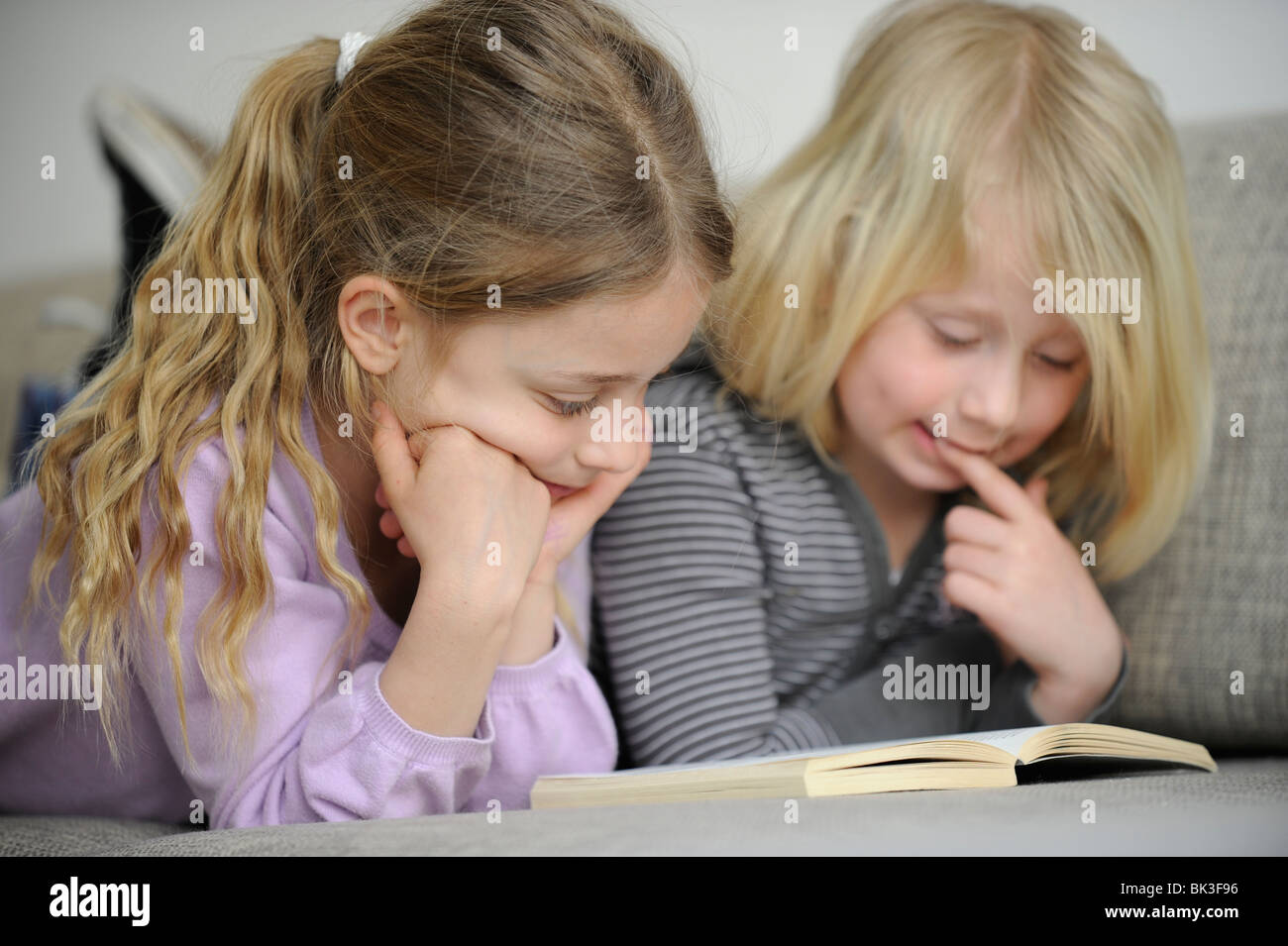 Young girls reading a book Stock Photo - Alamy