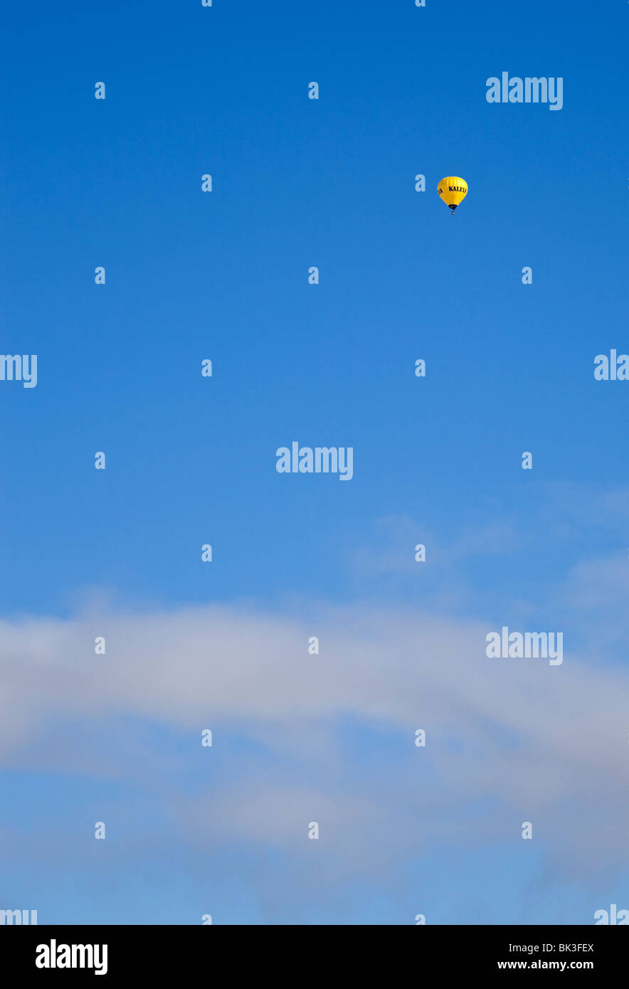Tiny yellow hot air balloon airborne at blue sky , Finland Stock Photo ...