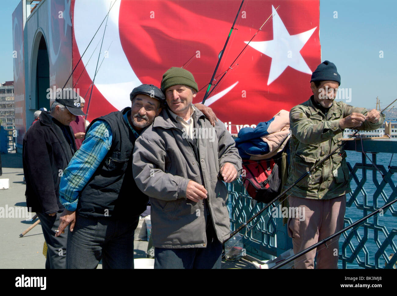 Middle Aged Men Fishing with Rods off Galata Bridge Istanbul Turkey ...