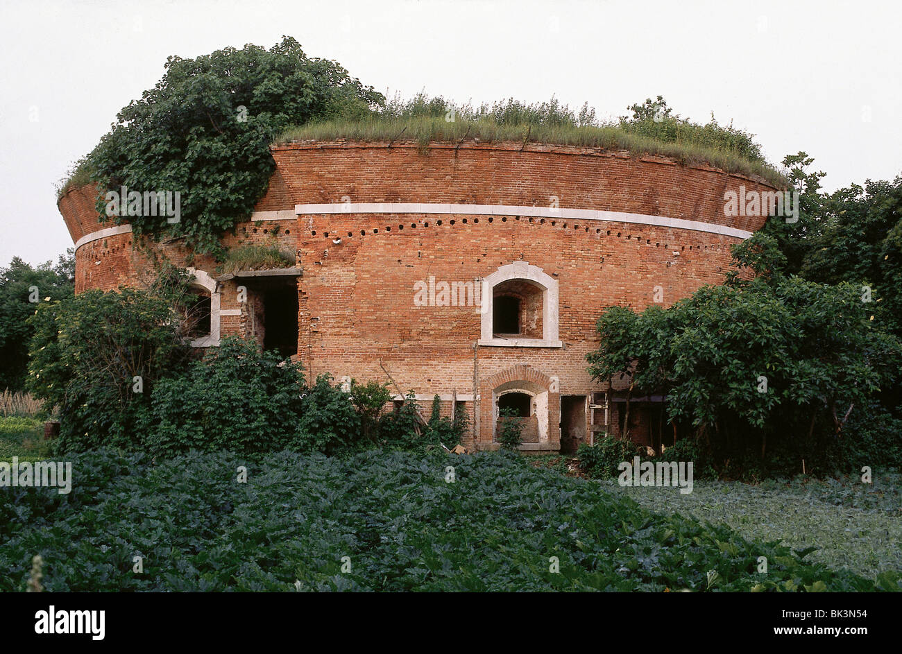 Architectural ruins of a round red brick historic site structure near ...