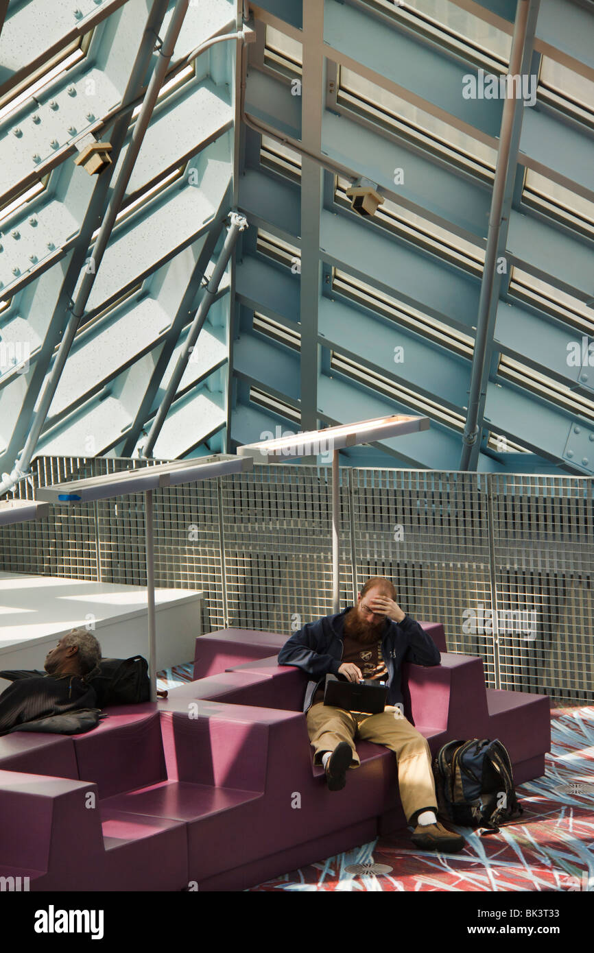 Man sits comfortably in reading area of the downtown main branch of the ...